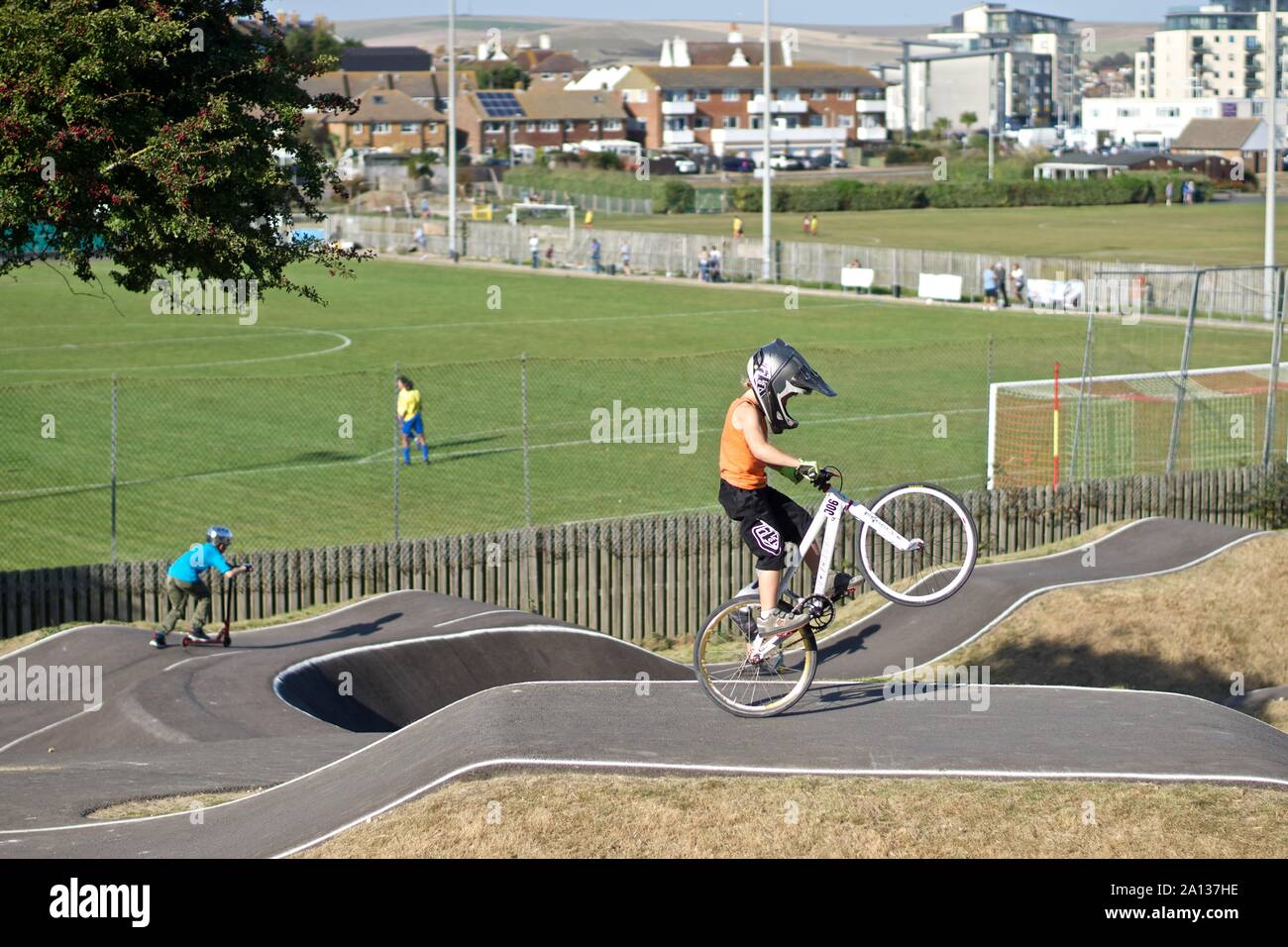 Kids riding on pump bike track Stock Photo - Alamy