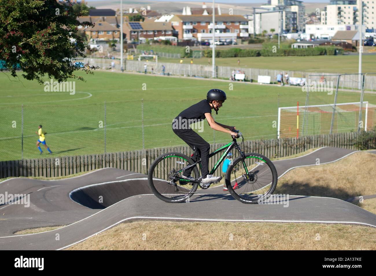 Kids riding on pump bike track Stock Photo - Alamy