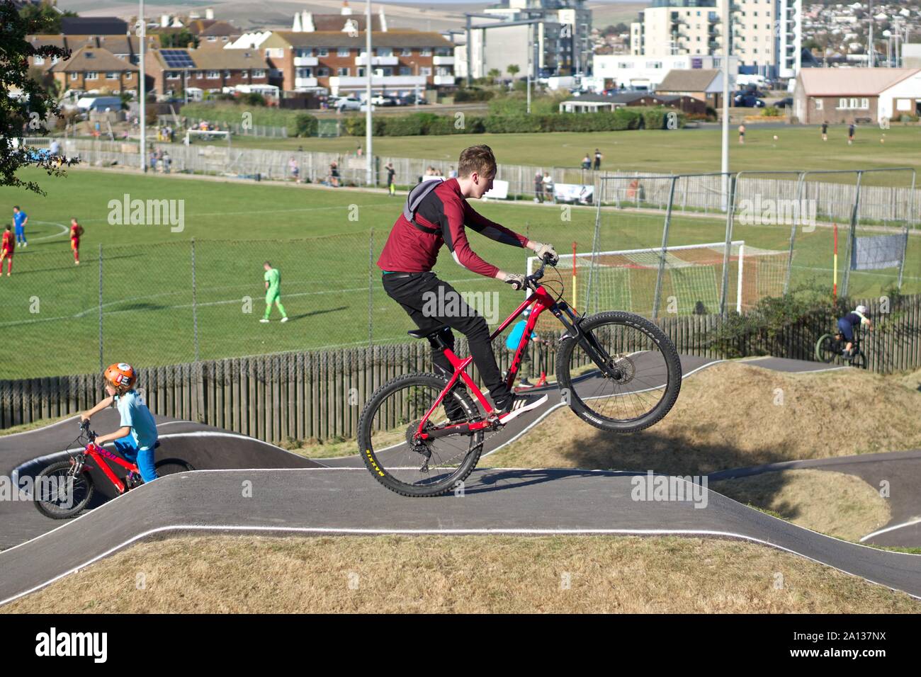 Kids riding on pump bike track Stock Photo - Alamy