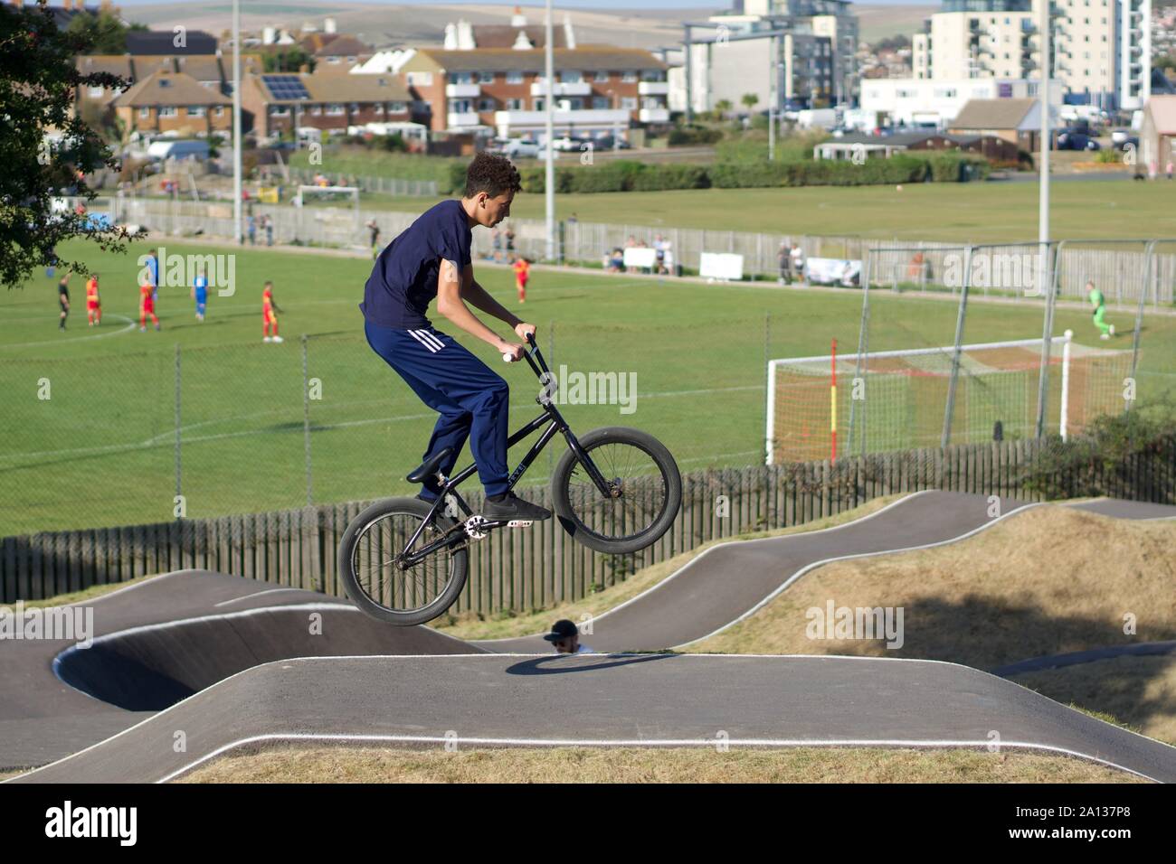 Kids riding on pump bike track Stock Photo - Alamy