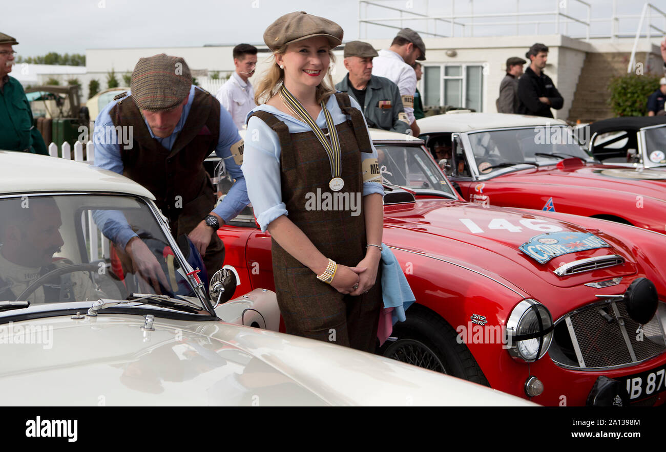 Lady standing beside Austin Healey in the assembly at The Goodwood ...