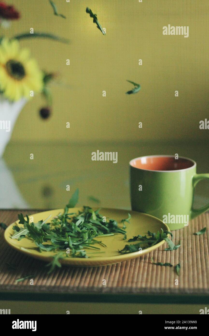 Tender leaves and cup of tea with pomegranate Stock Photo - Alamy