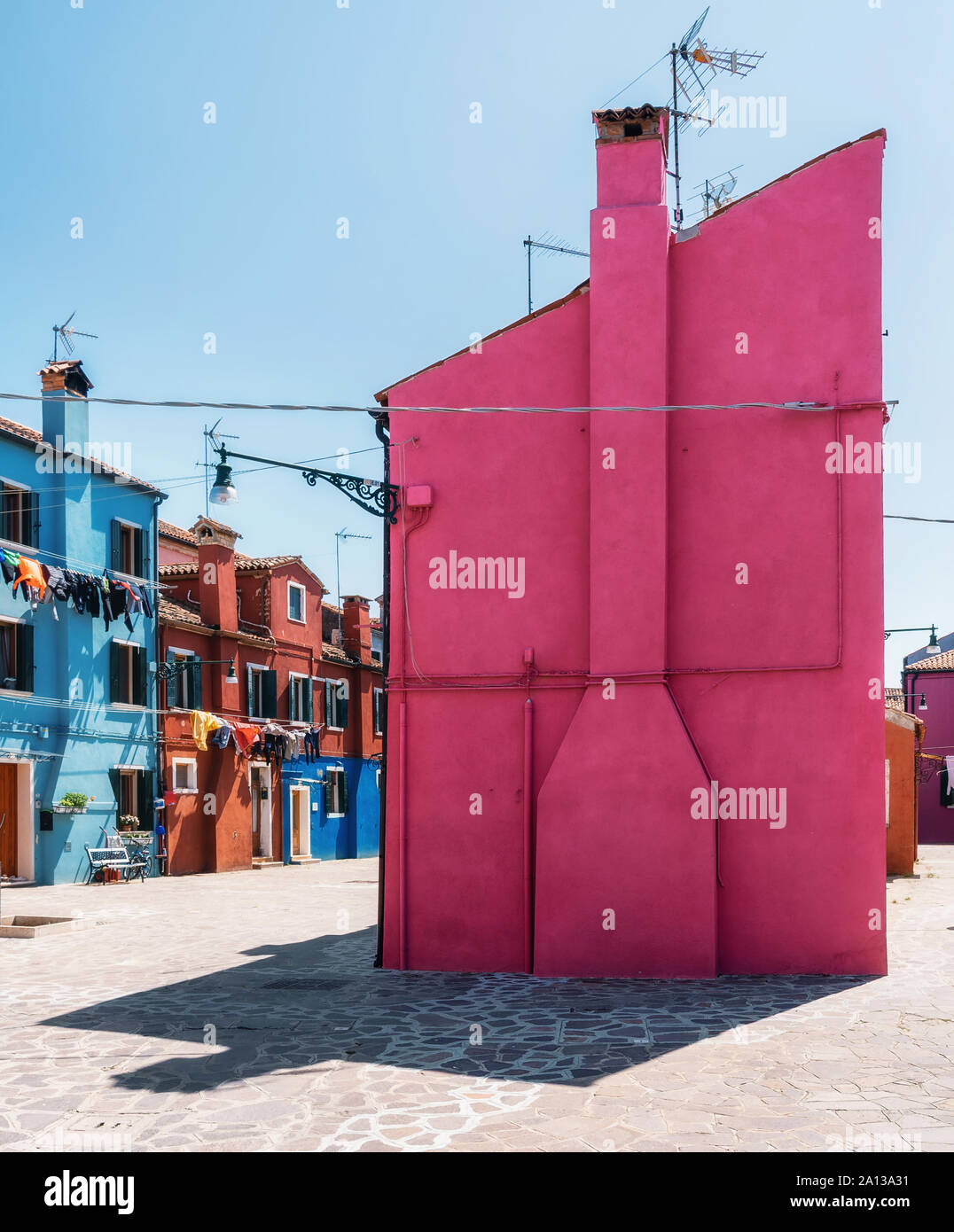 View of vivid pink stone house with chimney. Minimalism and free space ...