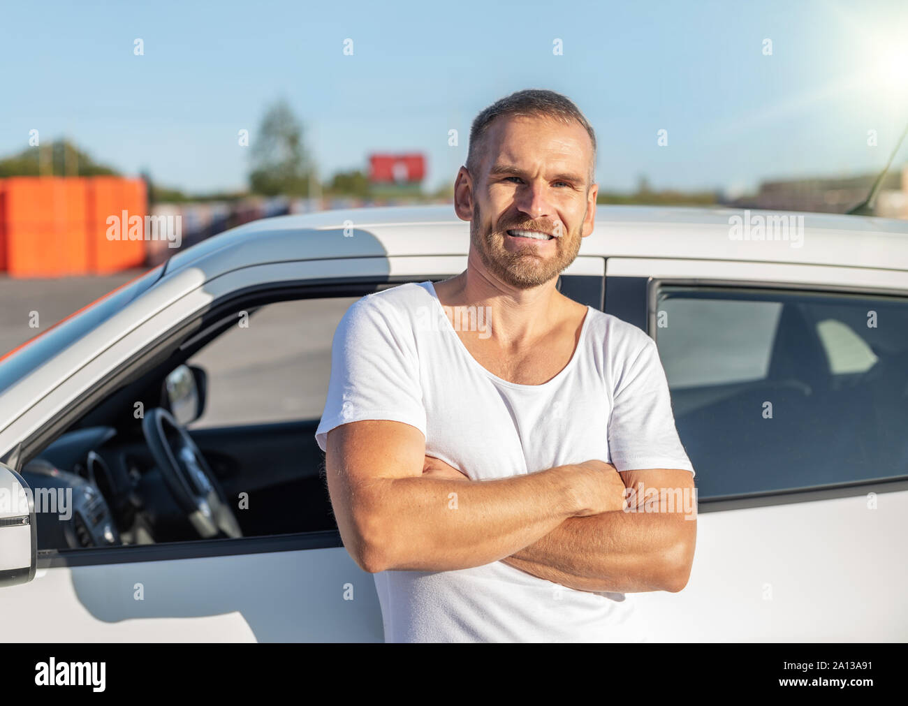 A man driving a white car Stock Photo - Alamy