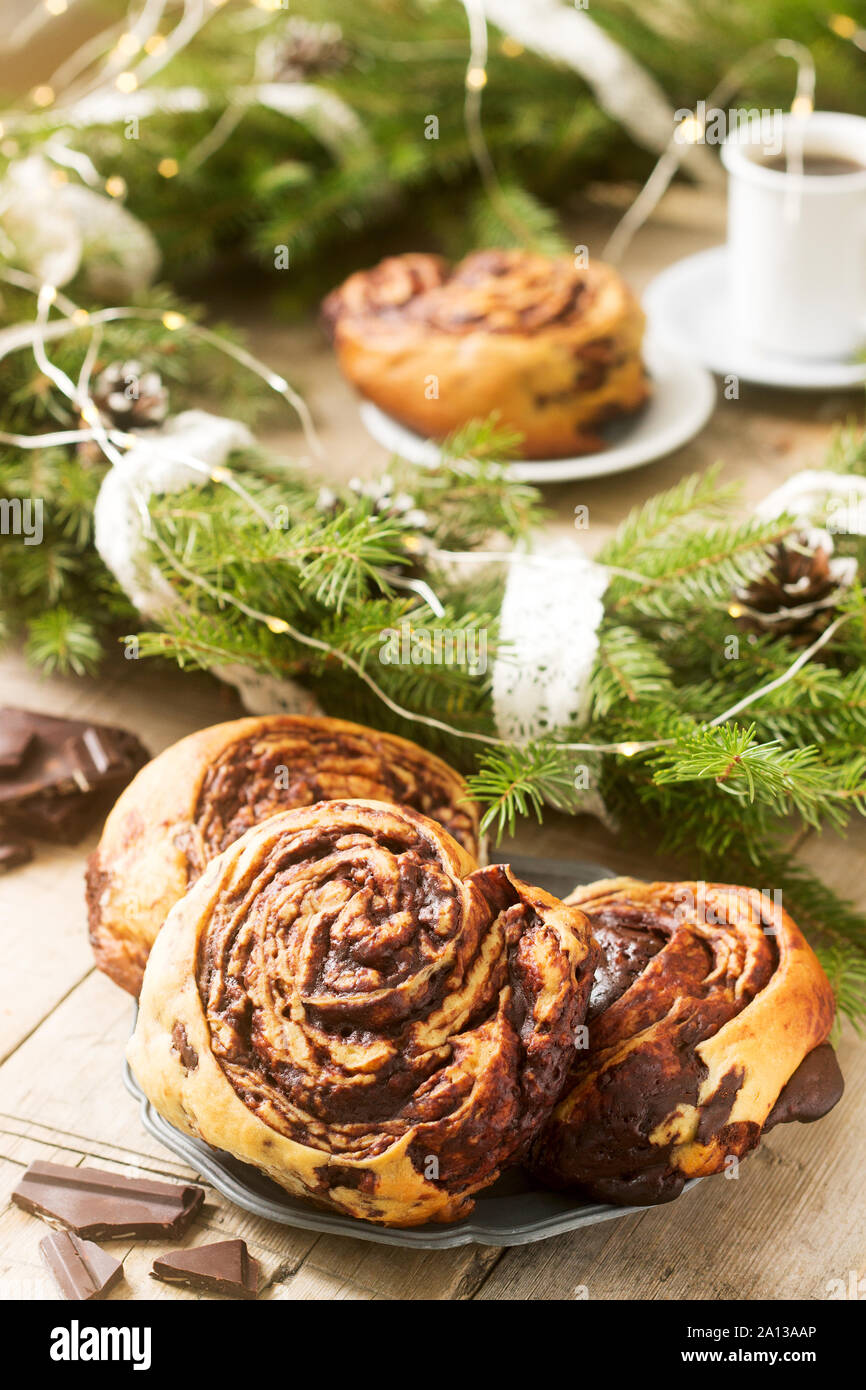 Snail chocolate muffins served with coffee on the background of a ...