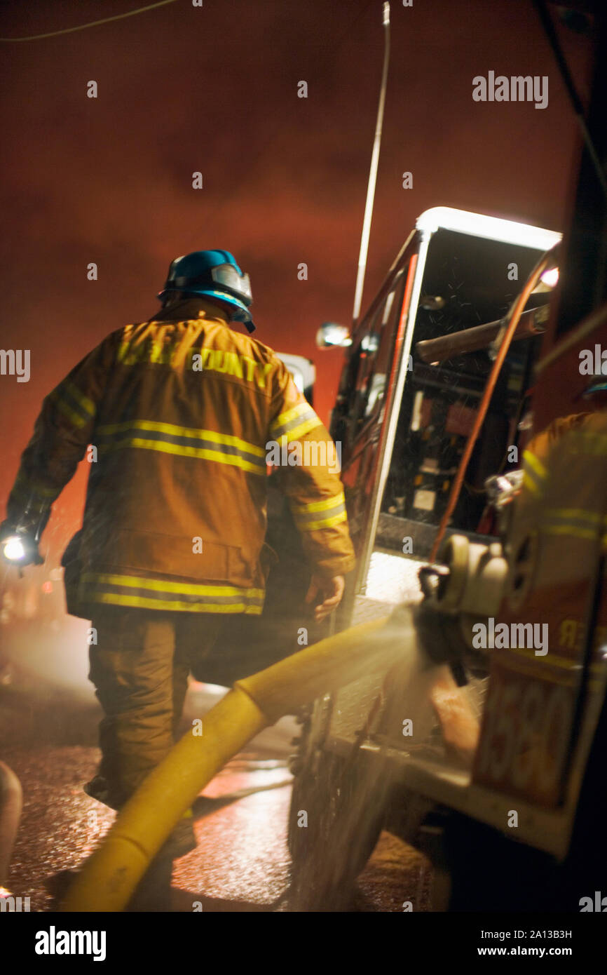 Rear view of a fire fighter Stock Photo - Alamy
