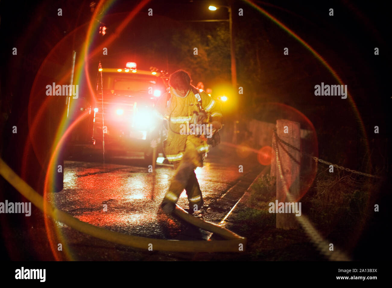 View of vehicles moving towards a firefighter Stock Photo - Alamy