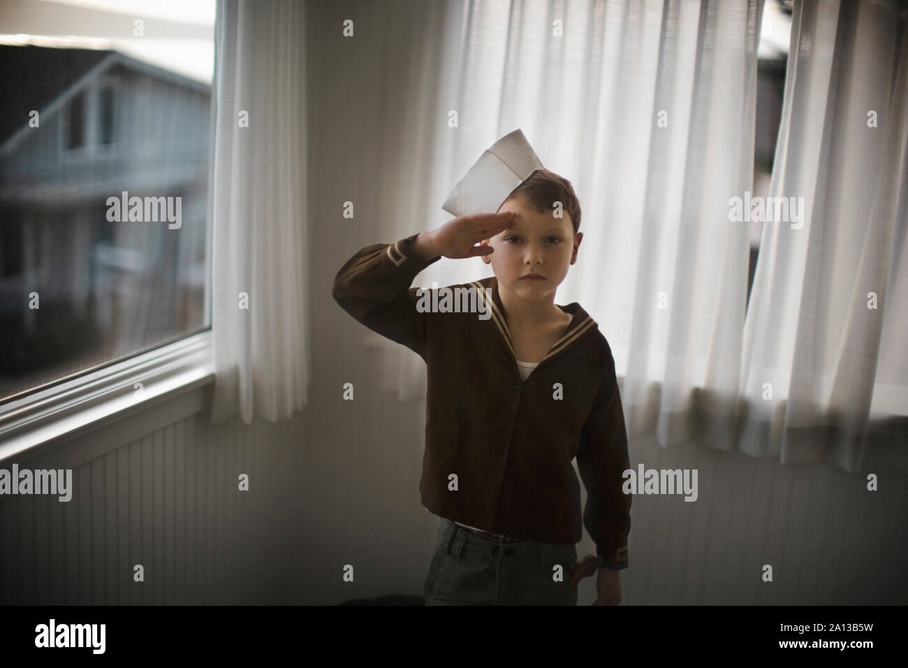View of a small boy saluting Stock Photo - Alamy