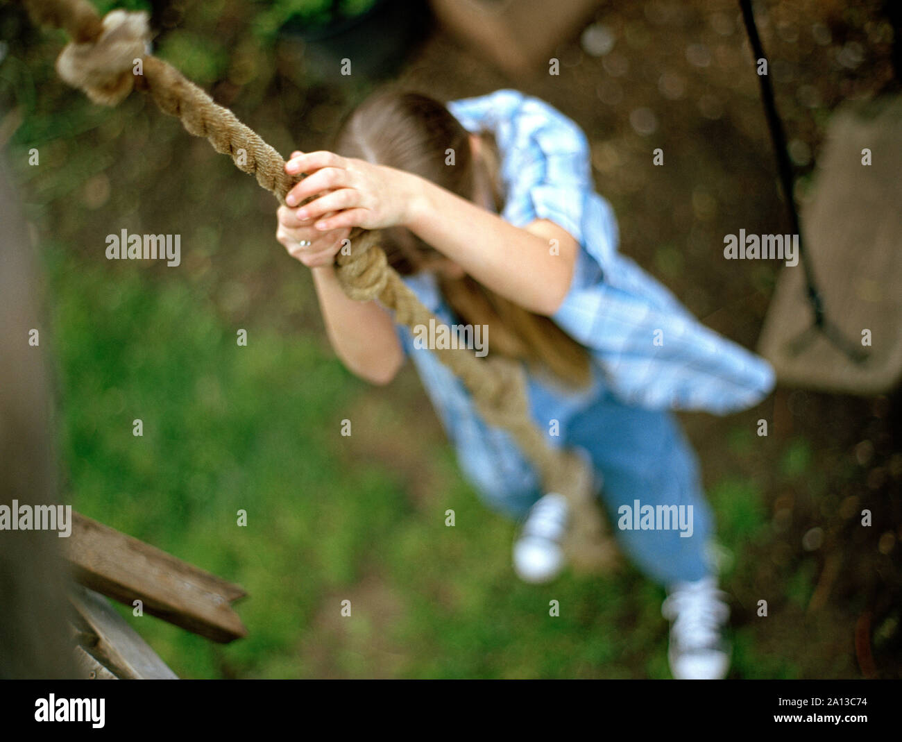 Girl playing on rope swing Stock Photo - Alamy