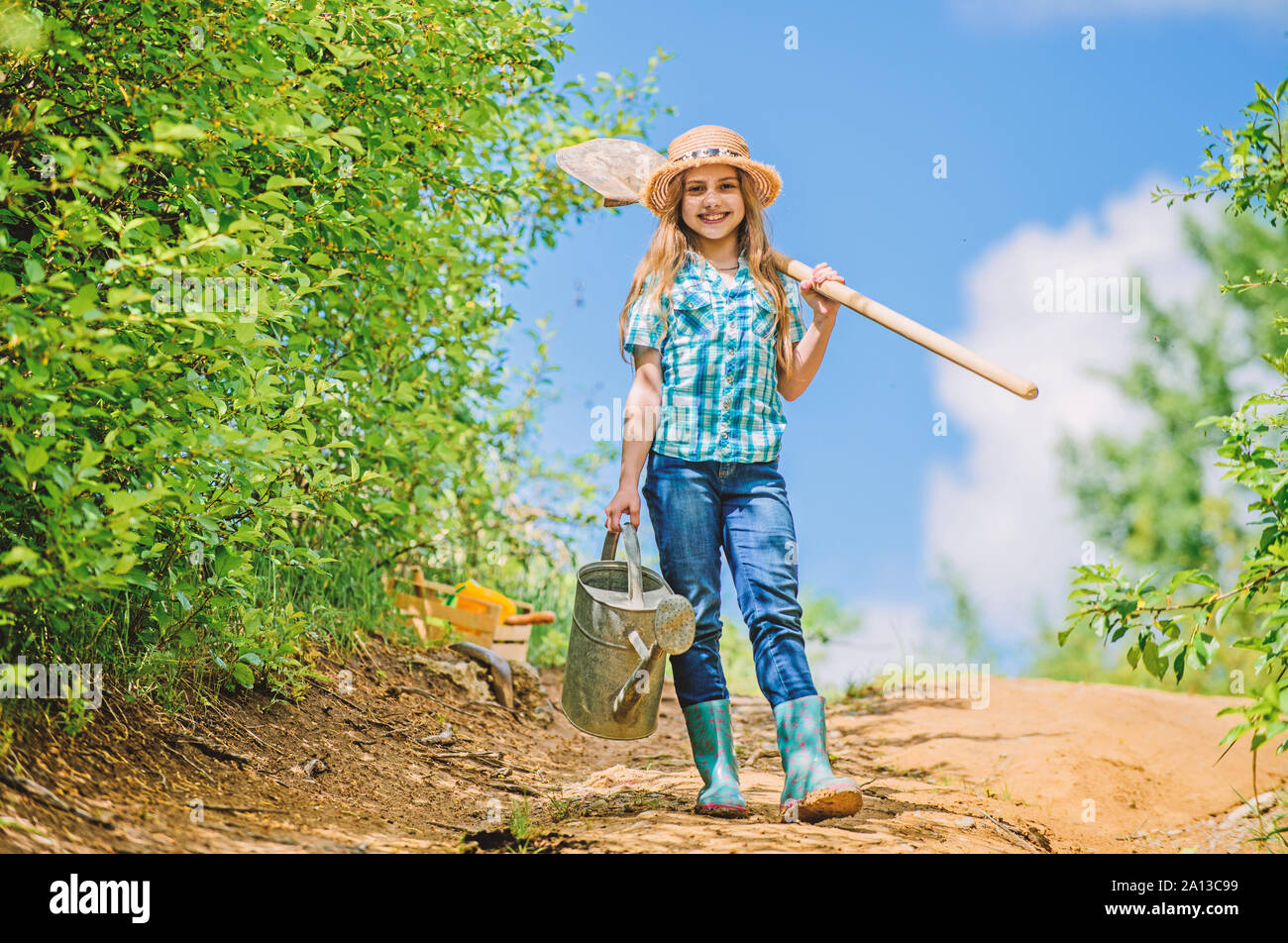 little girl on rancho. summer farming. farmer little girl. garden tools ...