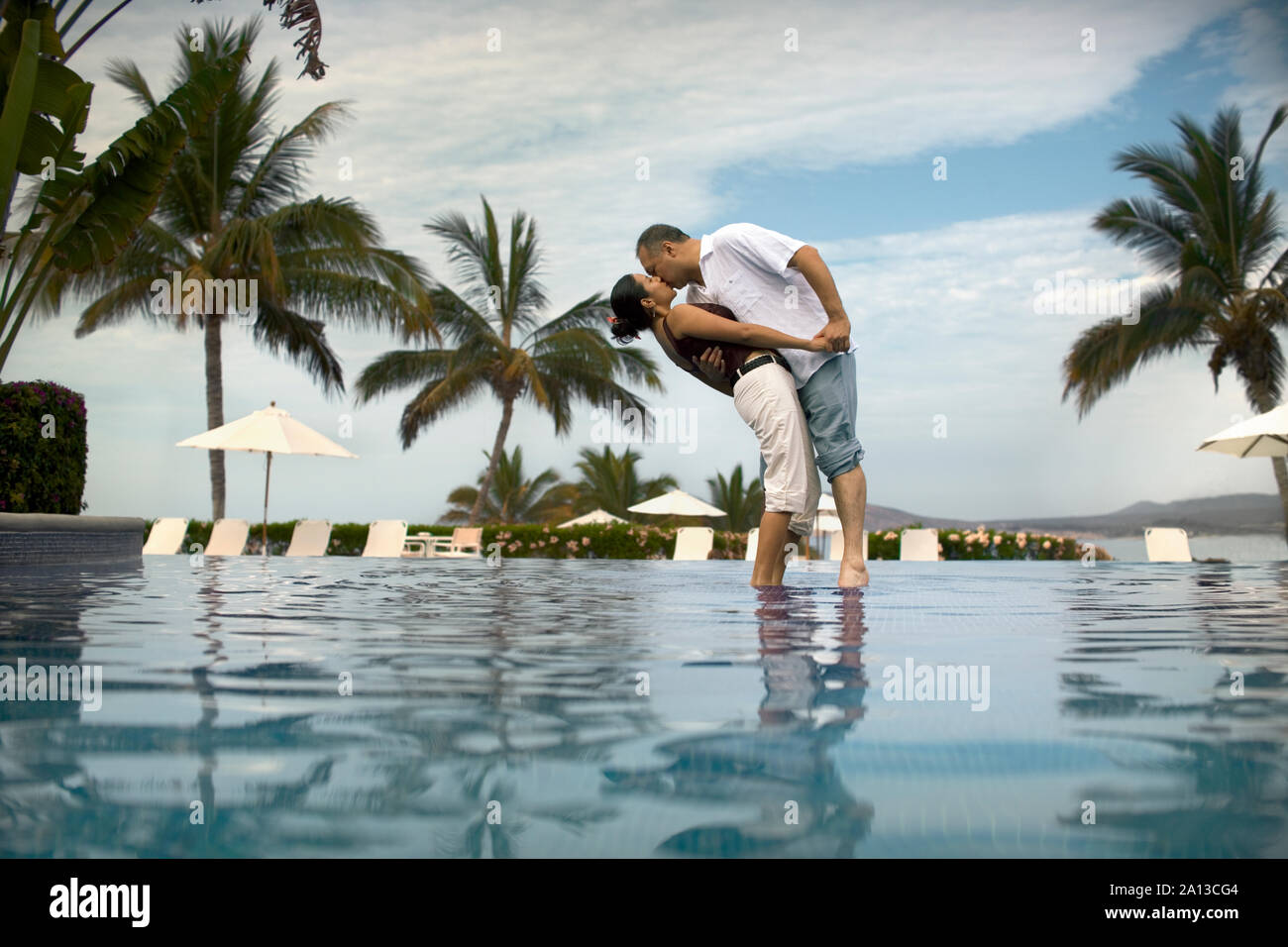 couple dancing by swimming pool Stock Photo - Alamy