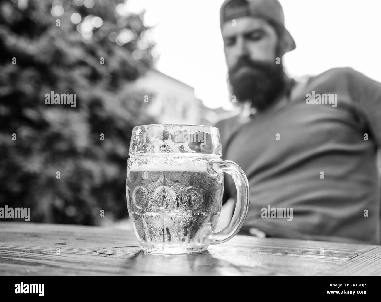 Man sit cafe terrace enjoying beer defocused. Craft beer is young ...