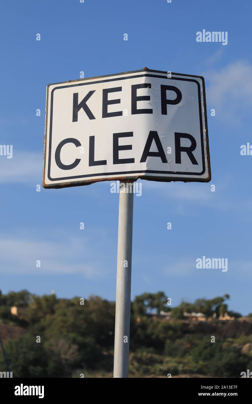 Keep clear road sign in blue sky background, vertical Stock Photo - Alamy