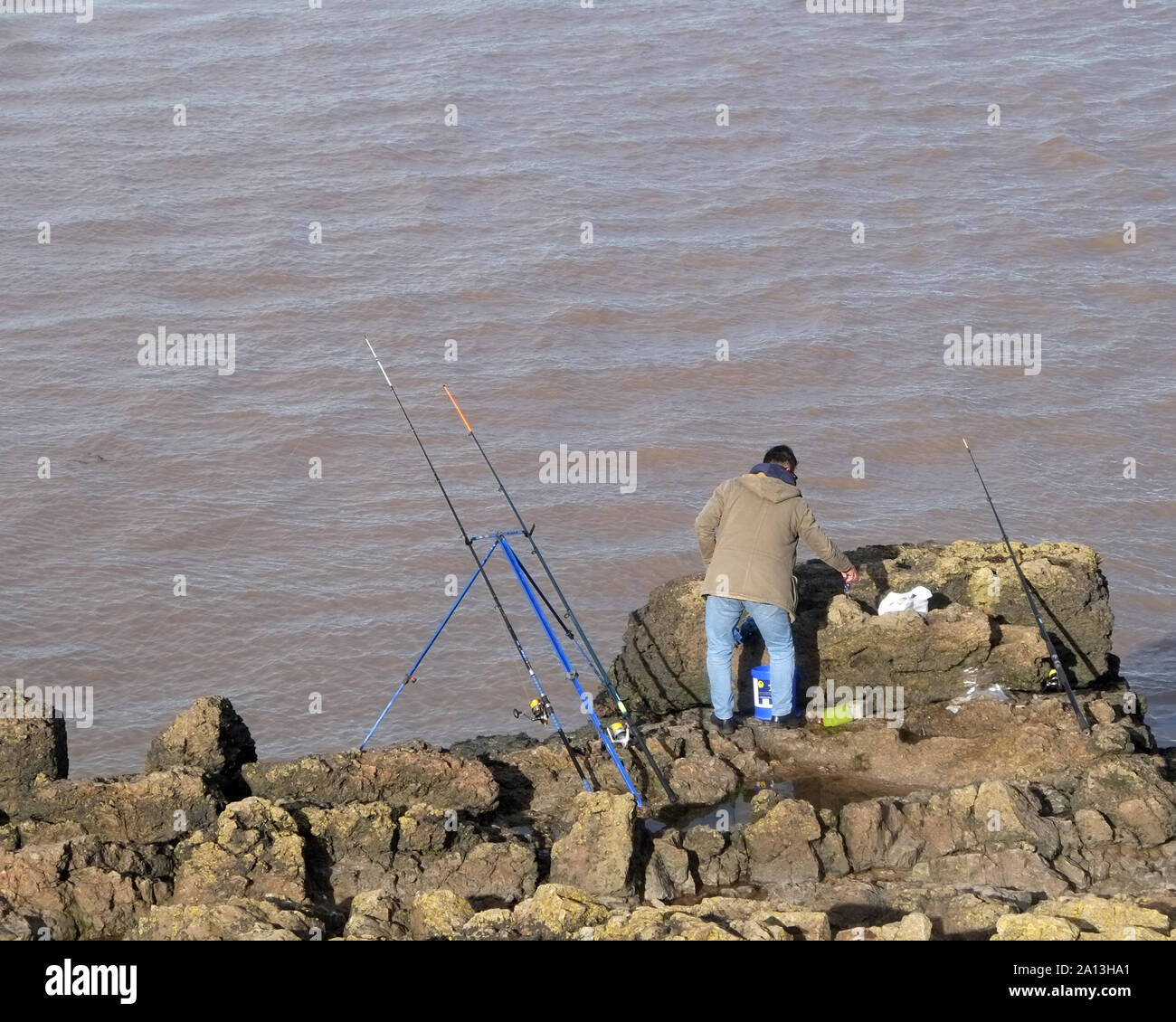 January 2019 - man fishing on the rocks at Portishead Stock Photo - Alamy