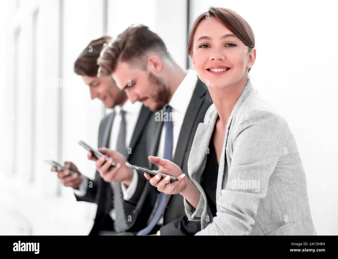 young employees using their smartphones Stock Photo - Alamy