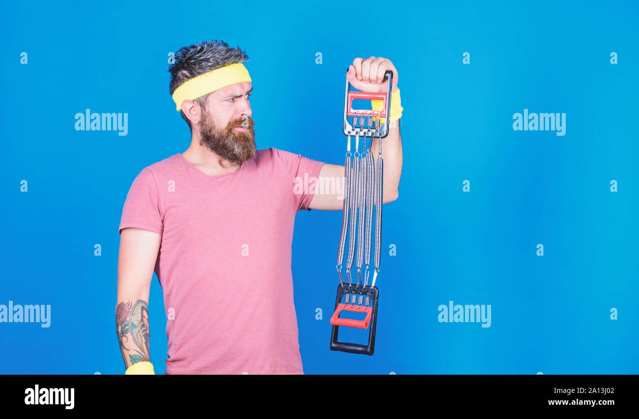 Athlete workout with expander. Man bearded athlete exercising with ...