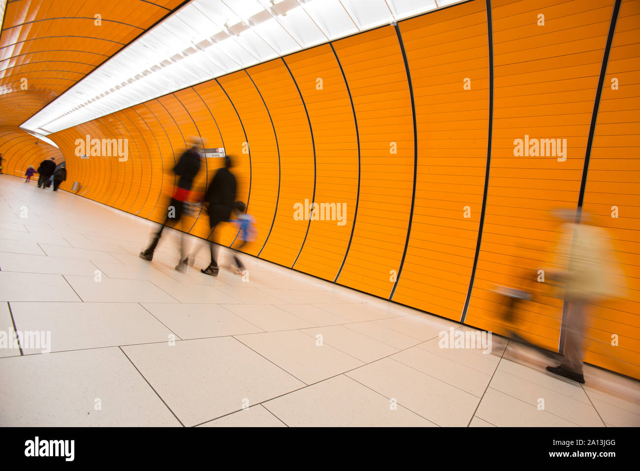 People rushing through a subway corridor (motion blur technique is used ...