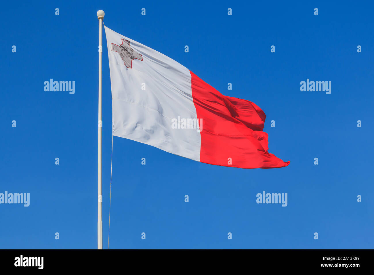 Malta national flag is waving in deep blue sky background Stock Photo ...