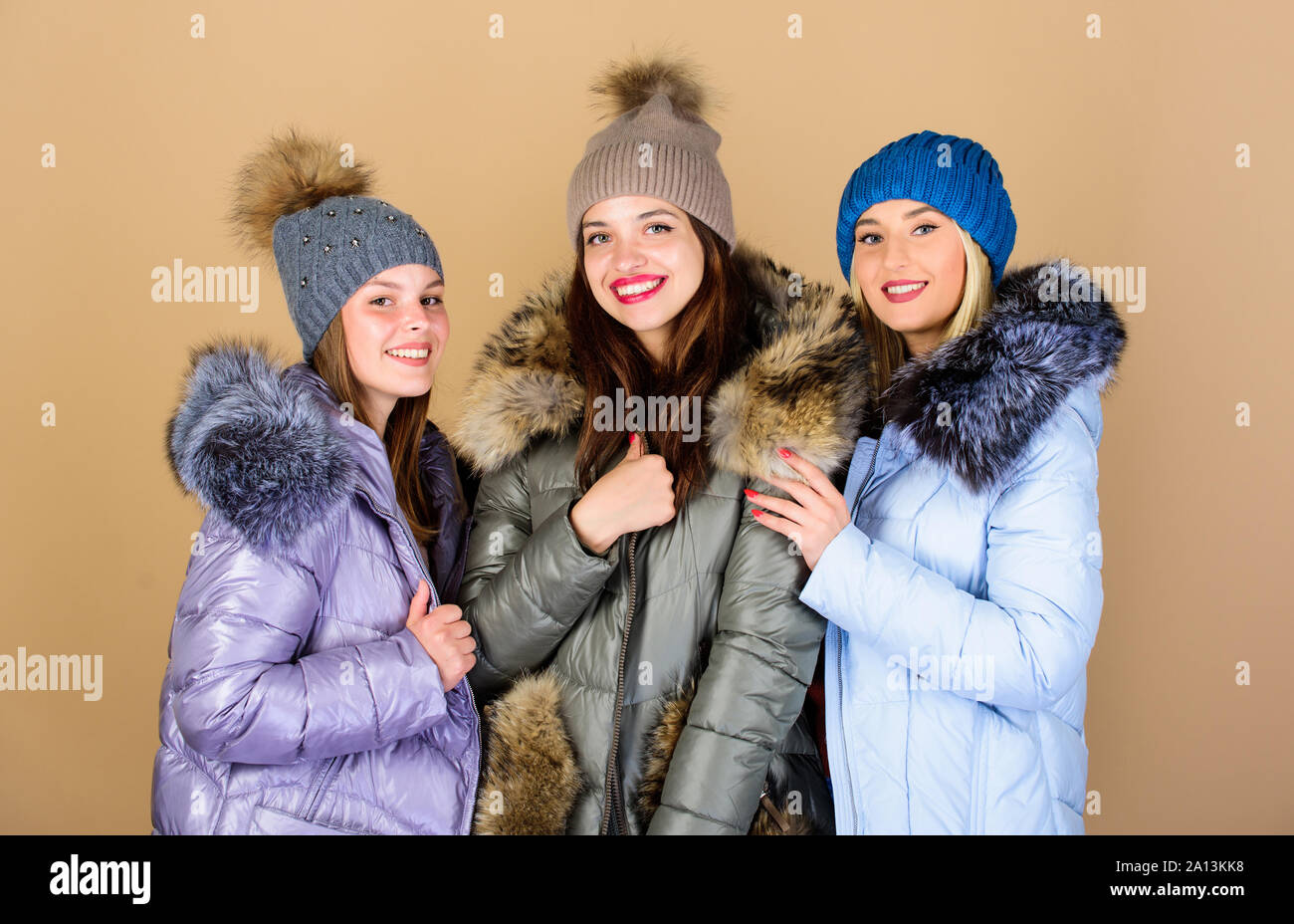 warm embrace. girls in beanie. winter clothing fashion. faux fur down ...