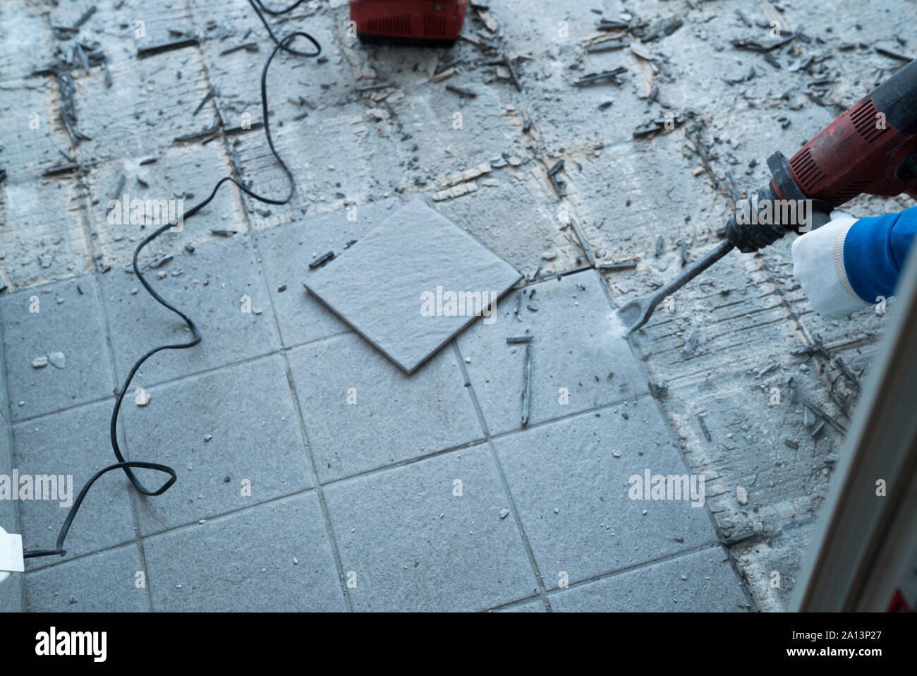 Worker chipping floor tiles hi-res stock photography and images - Alamy