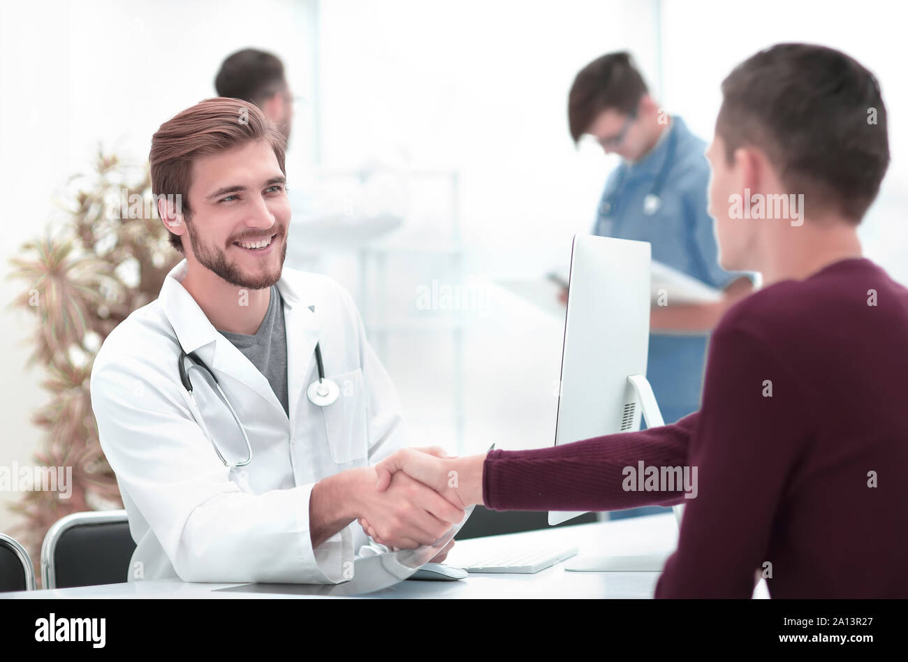 Doctor giving handshake patient hi-res stock photography and images - Alamy