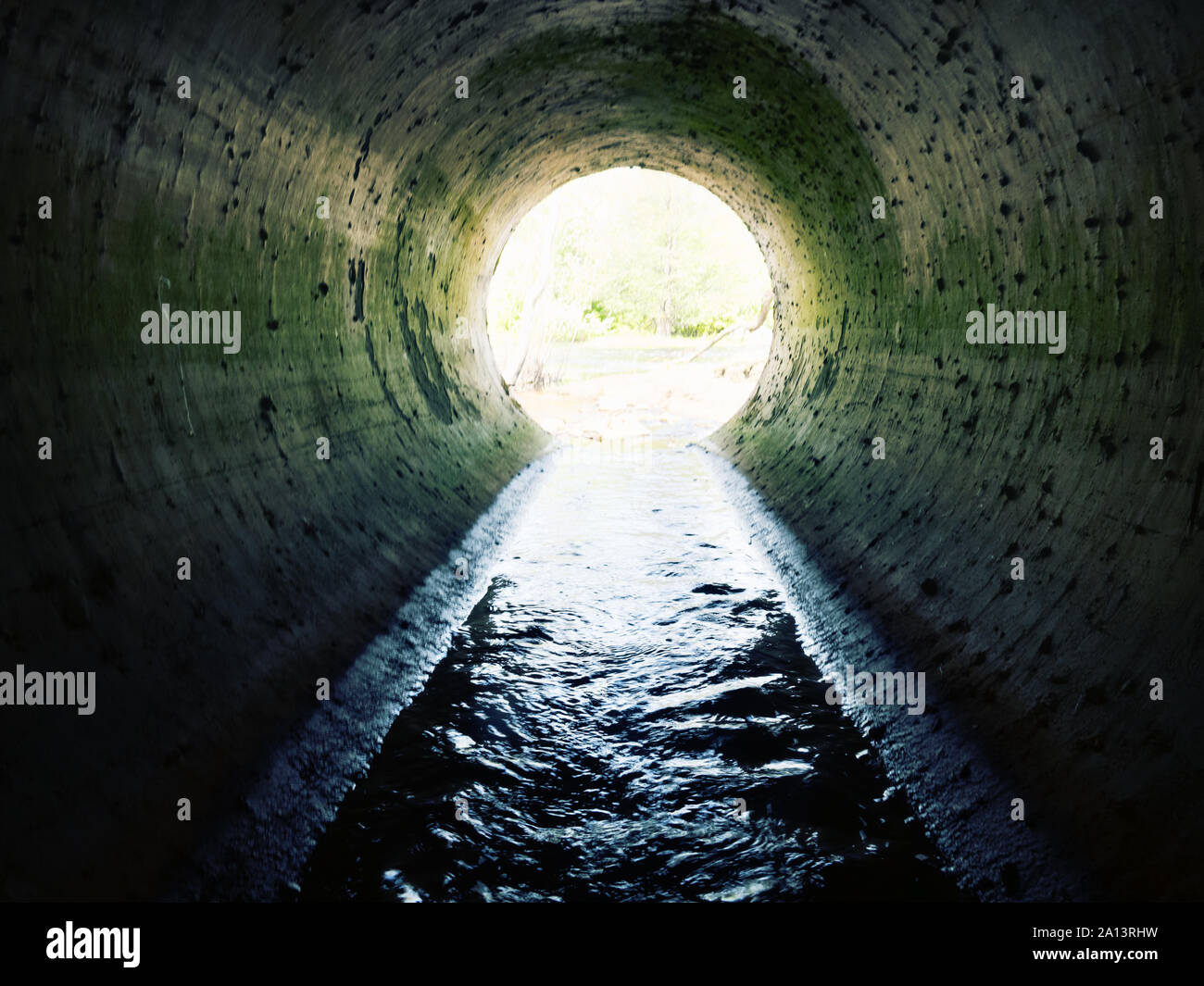 Drainage pipe under the highway (culvert). Filming inside the pipe ...