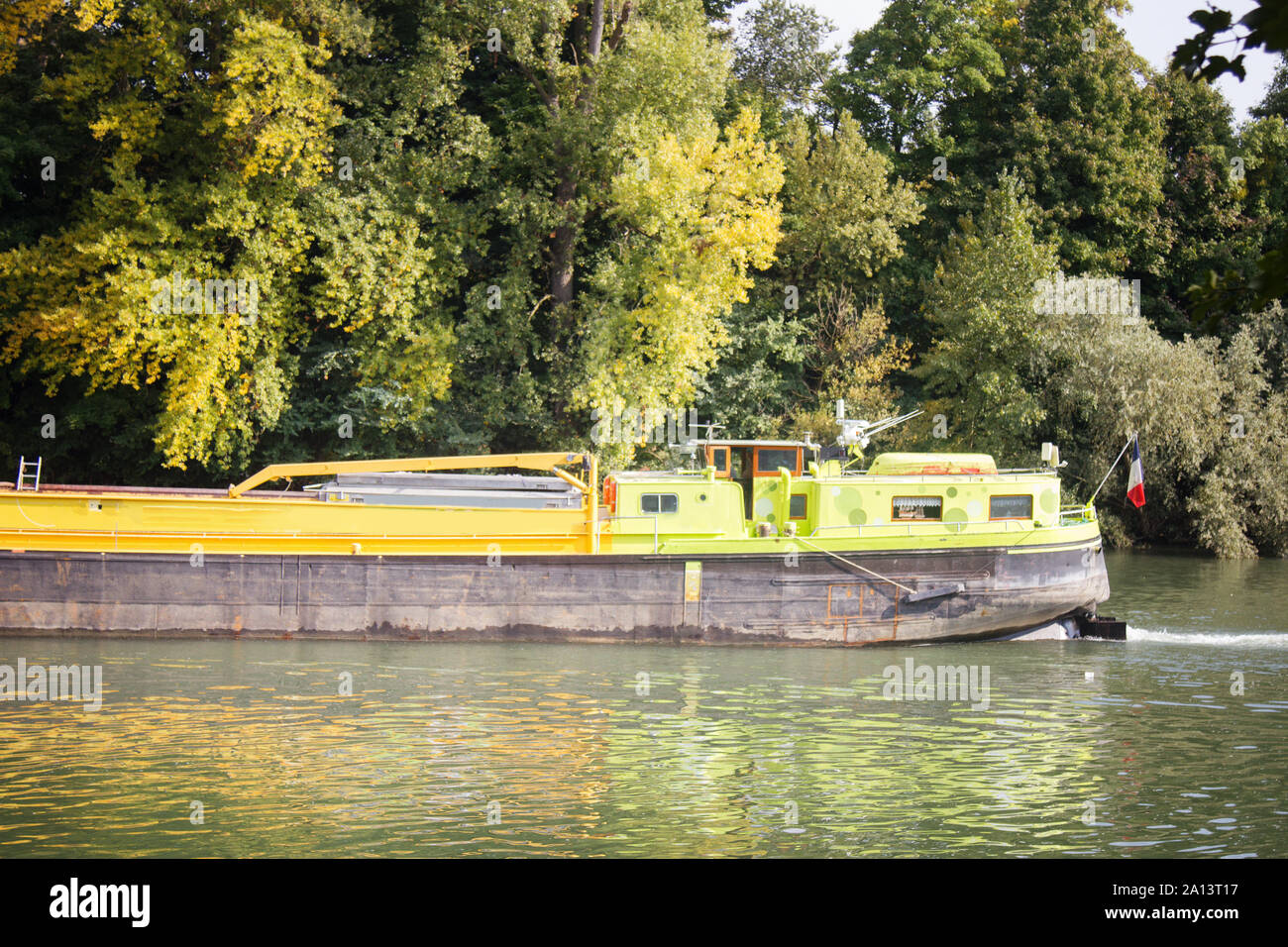 River navigation in France. Barge on Seine. cargo ships floating along ...