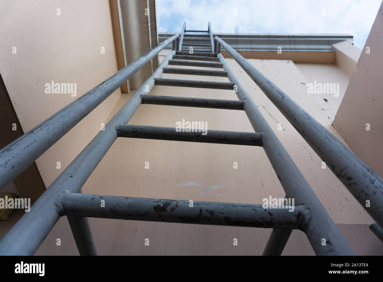 Staircase leading to a rooftop of a building. Gray metal stairways ...