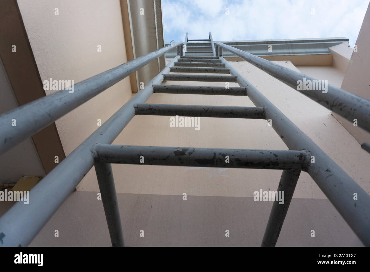 Staircase leading to a rooftop of a building. Gray metal stairways ...
