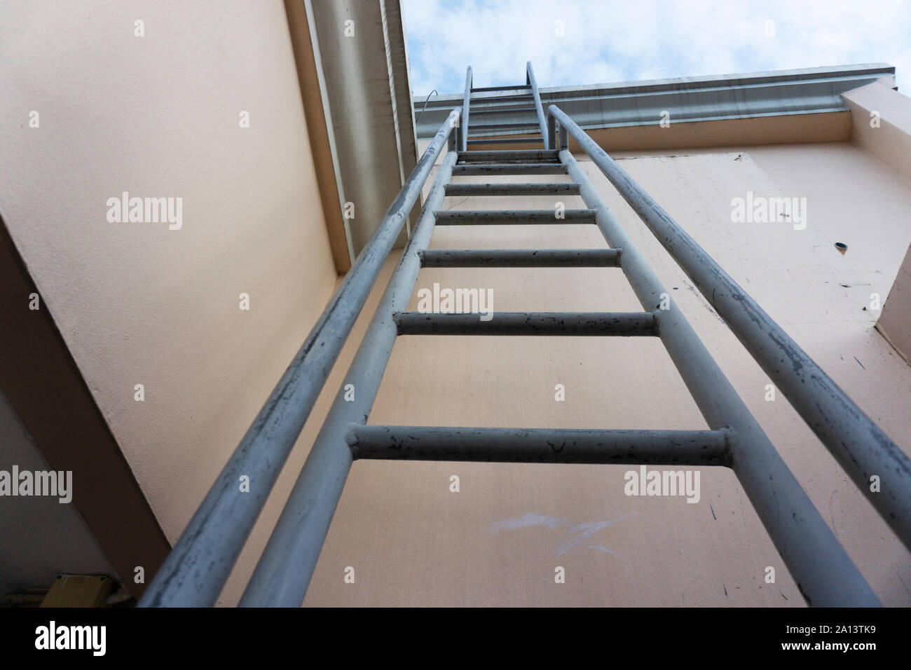 Staircase leading to a rooftop of a building. Gray metal stairways ...