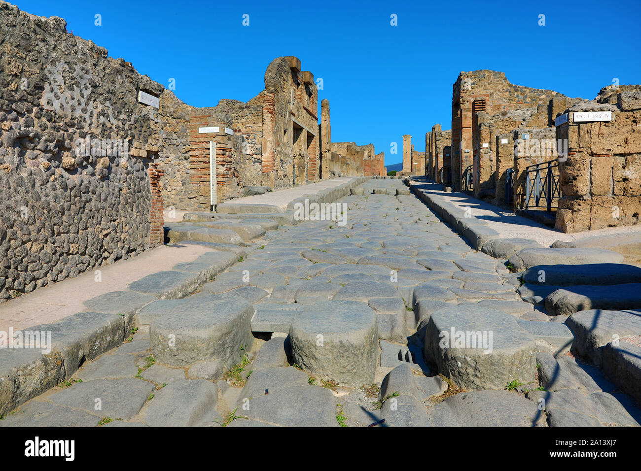 Street and ruins of houses in the ancient Roman city of Pompeii, Italy ...