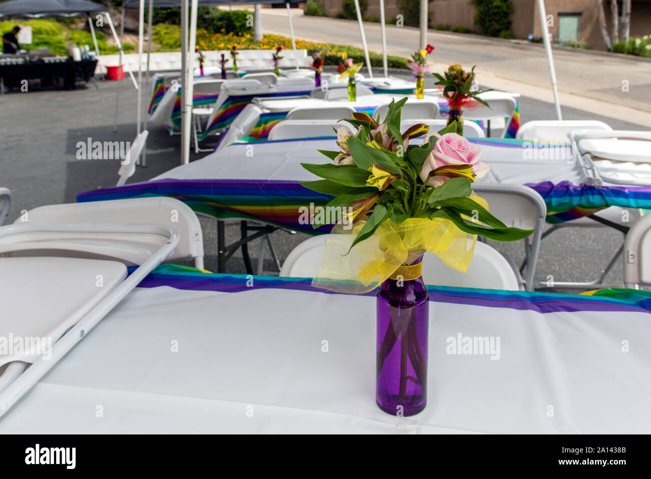 Pink rose flower arrangements decorate the party event tables on the ...