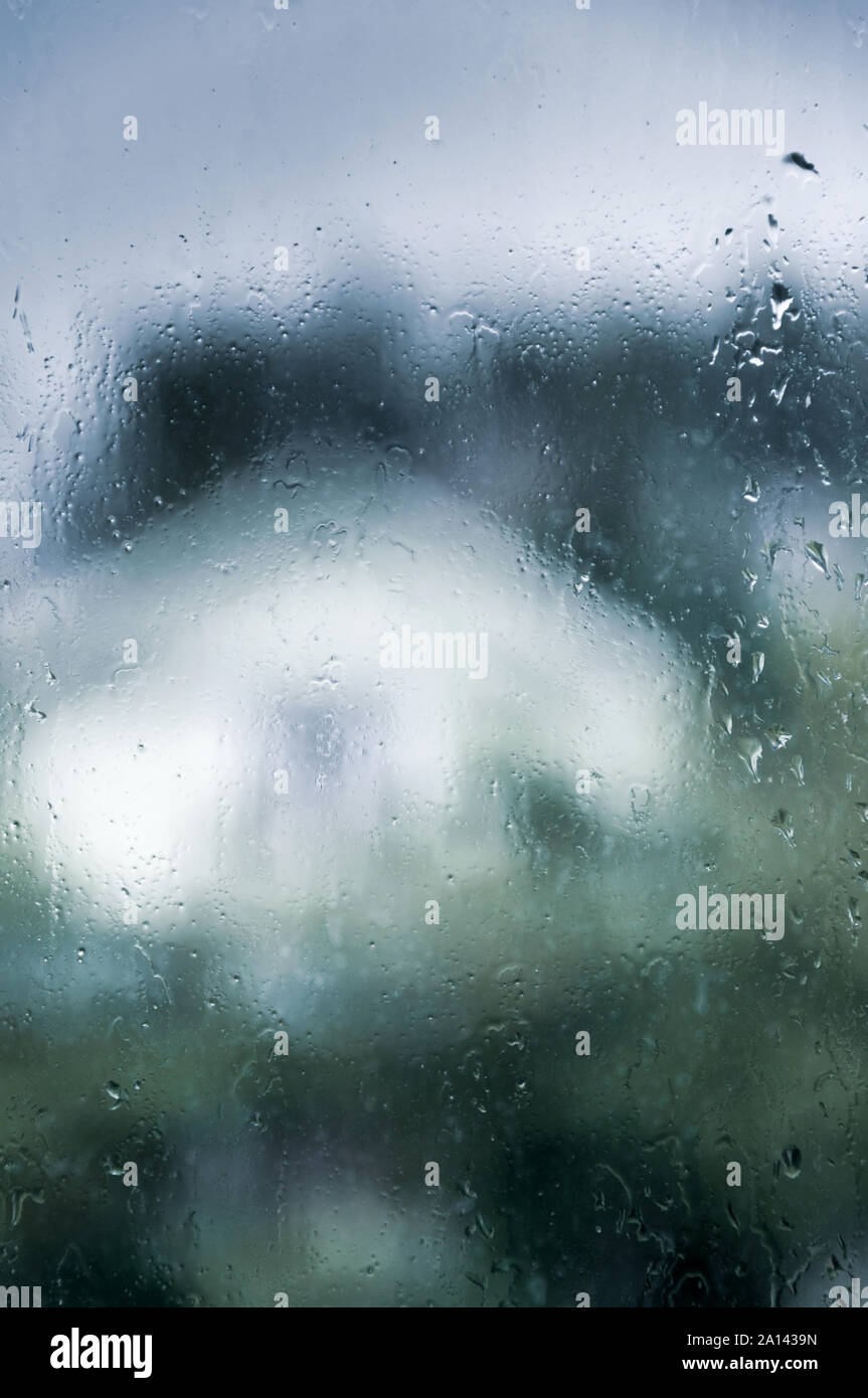 wet glass of window with raindrops, estate garden Stock Photo - Alamy