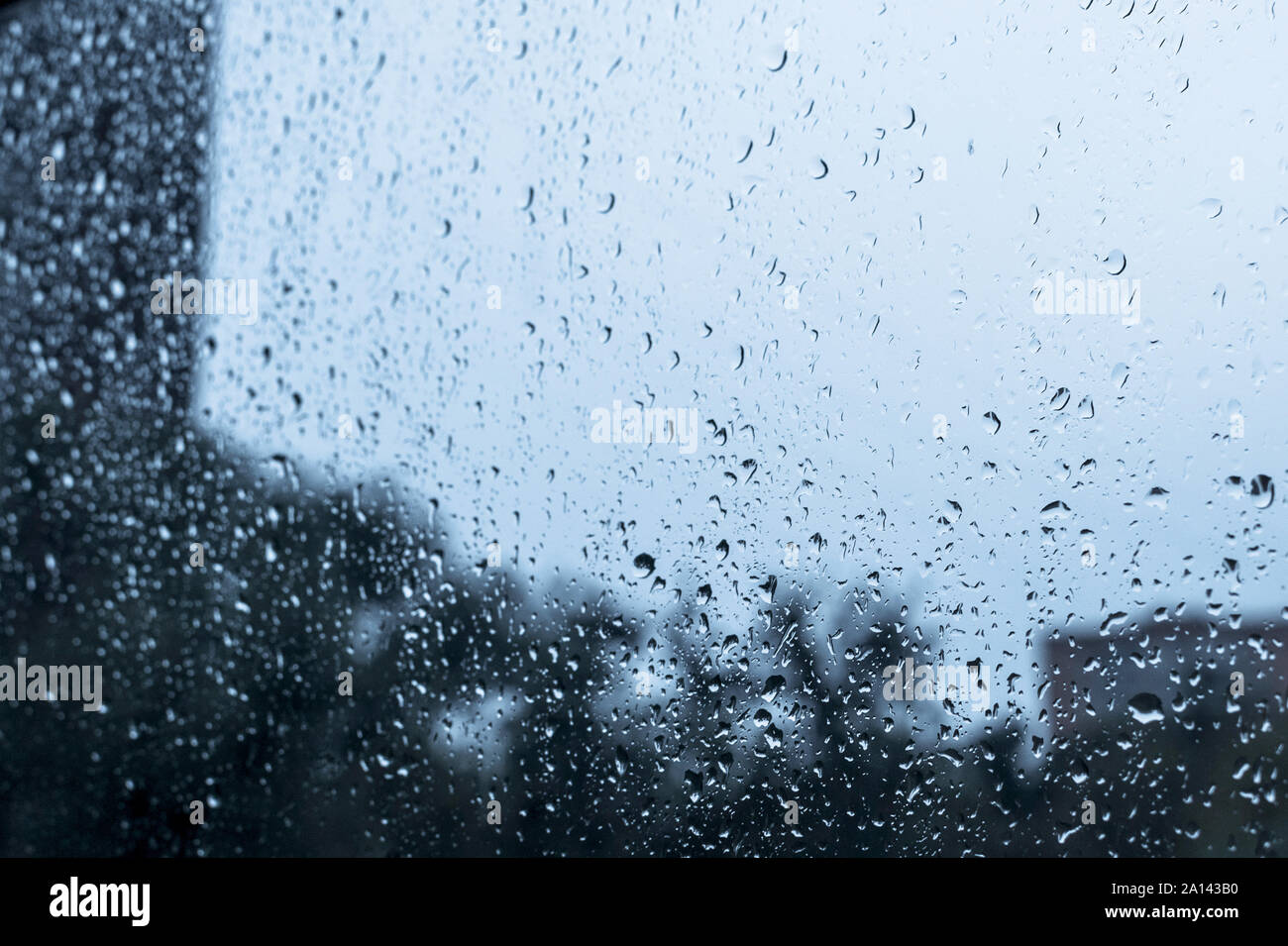 rainy day in the city, view through wet window Stock Photo - Alamy