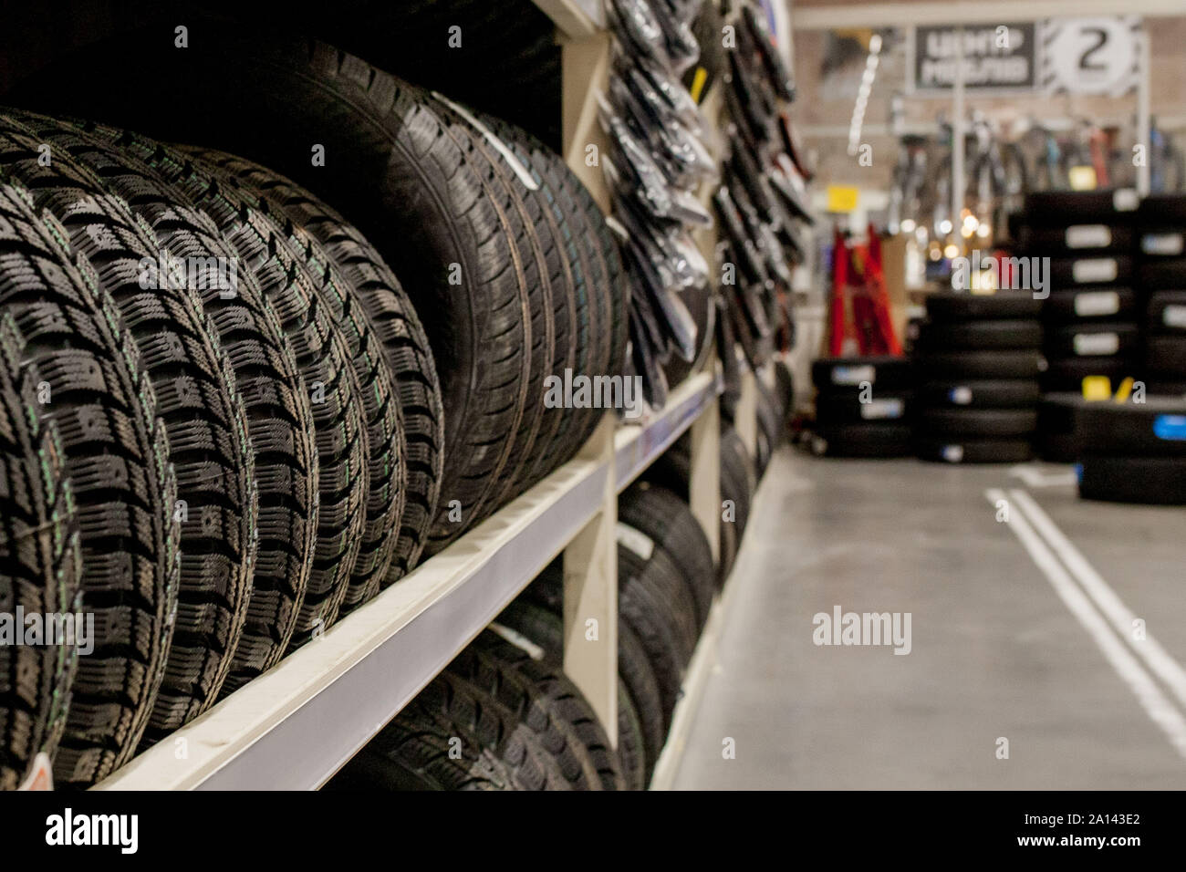 Car tires and wheels at warehouse in tire store Stock Photo - Alamy