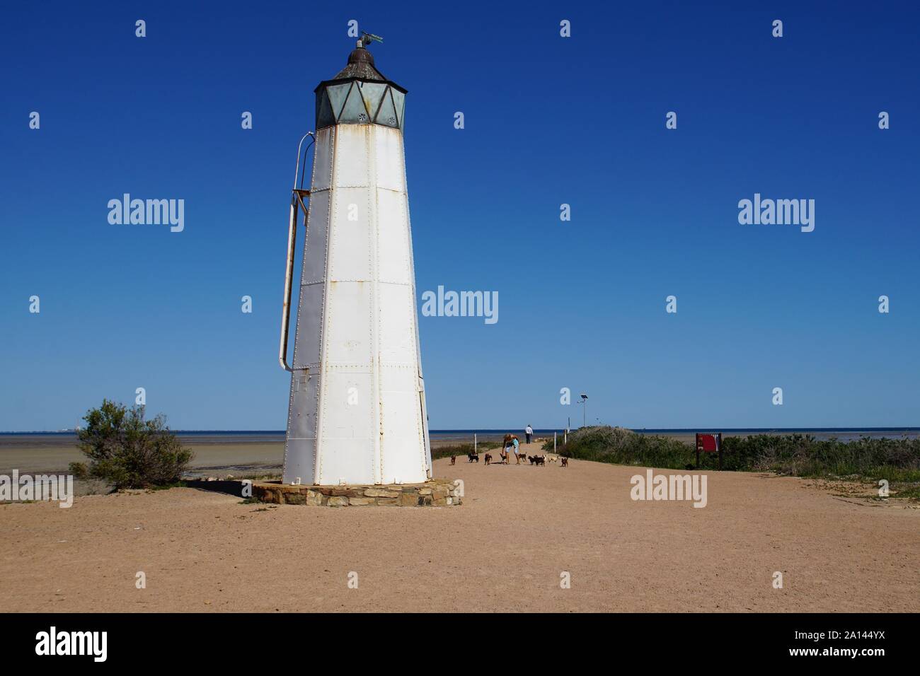 Lighthouse at the Entrance to a very long Jetty Stock Photo - Alamy