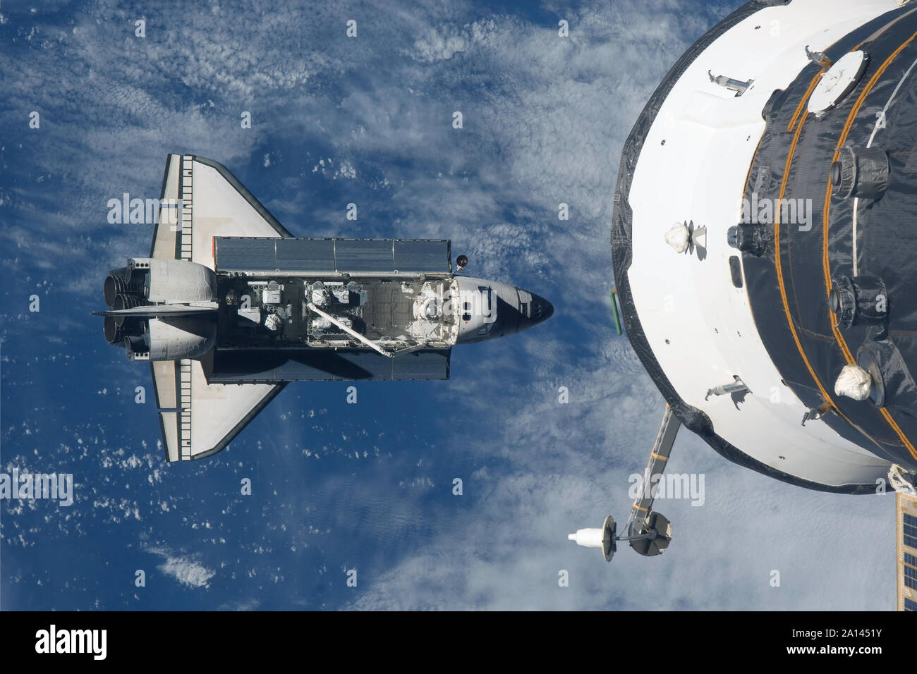 Space shuttle flies under the space station. Elements of this image ...