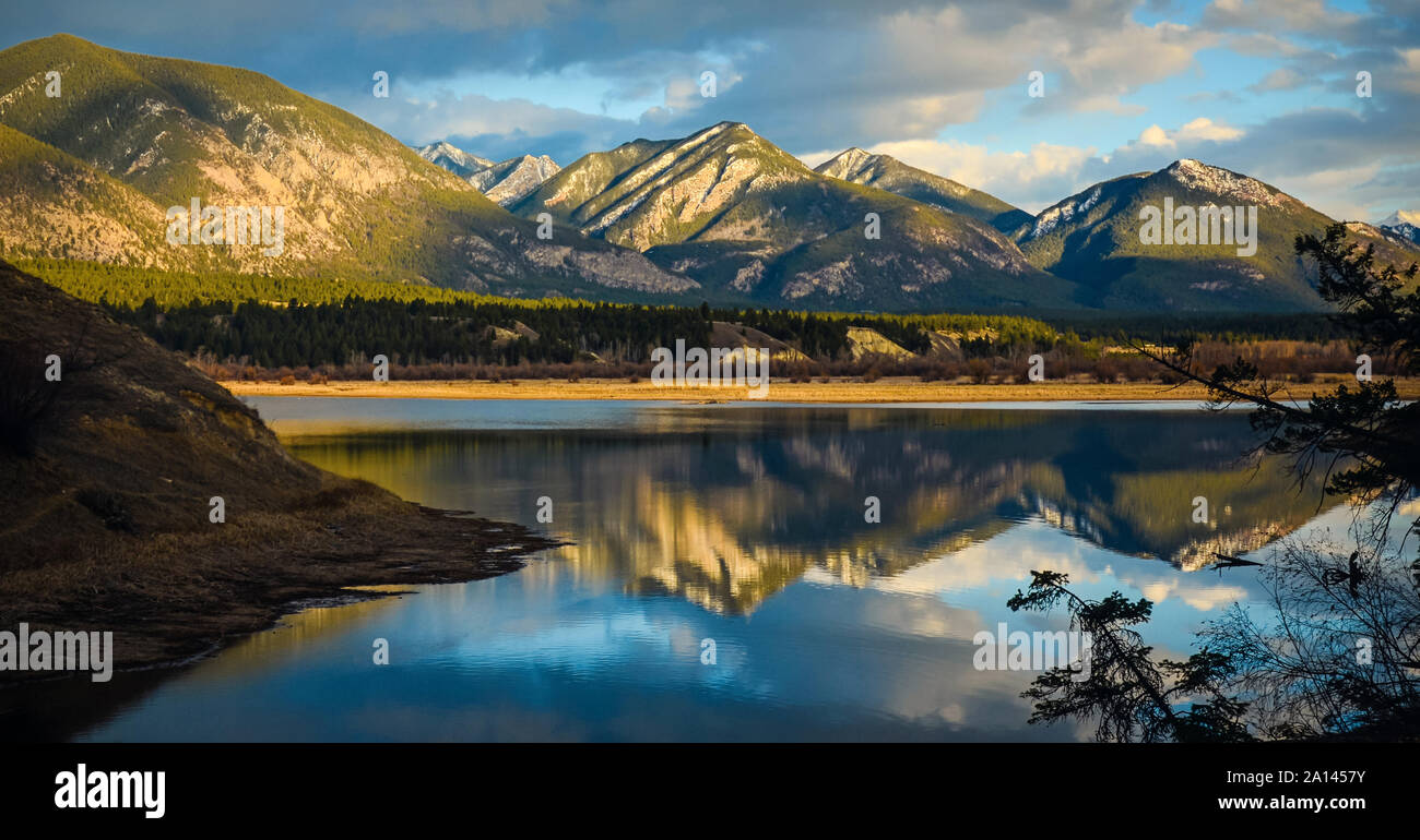 Golden hour landscape reflection of the Rocky Mountains in the Columbia ...