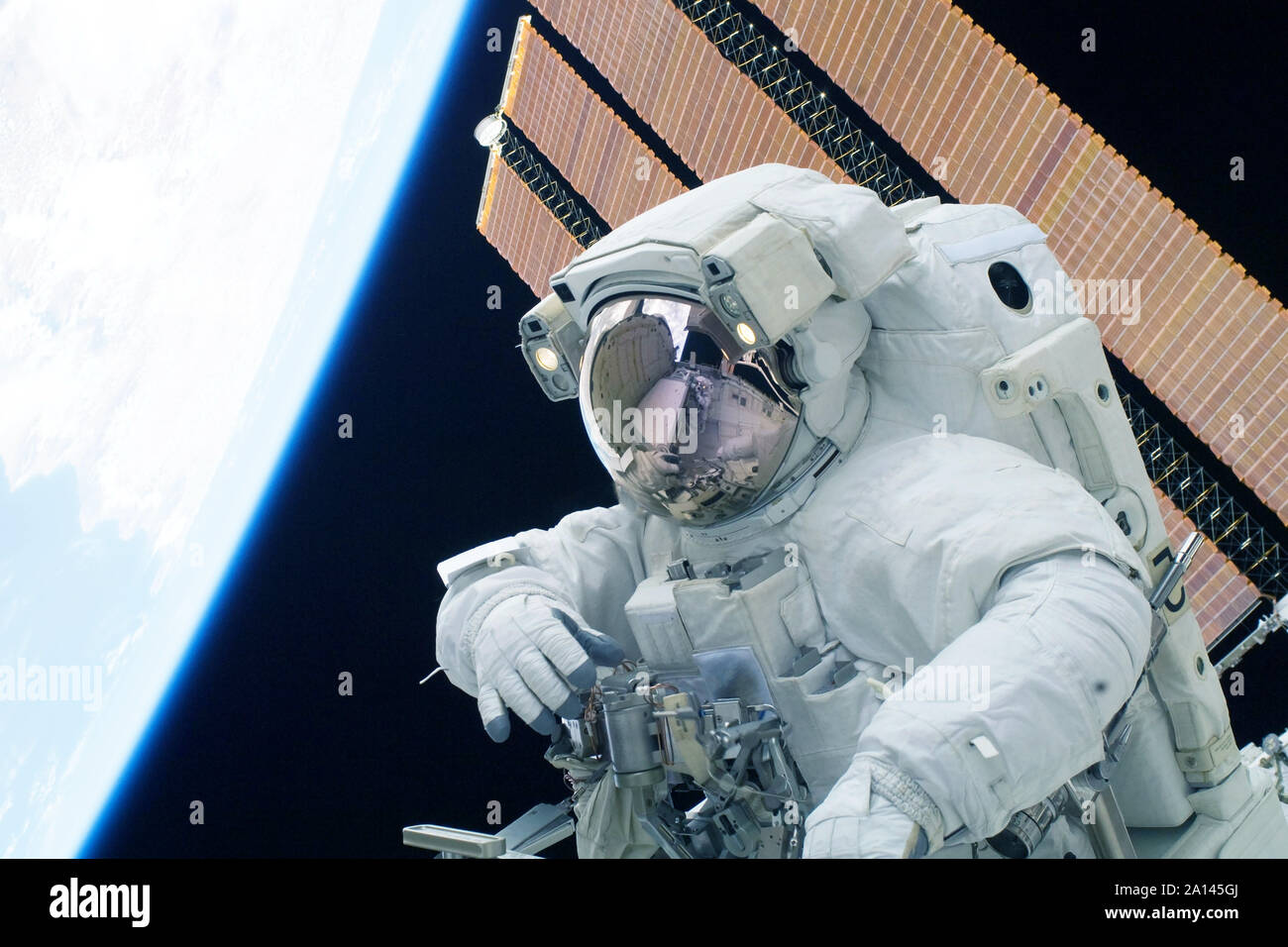 Astronaut in a spacesuit at the space station. Elements of this image ...