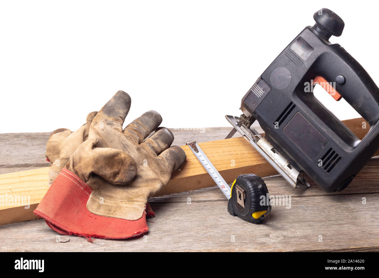 wooden workshop with a jigsaw (hacksaw), tape measure and construction ...