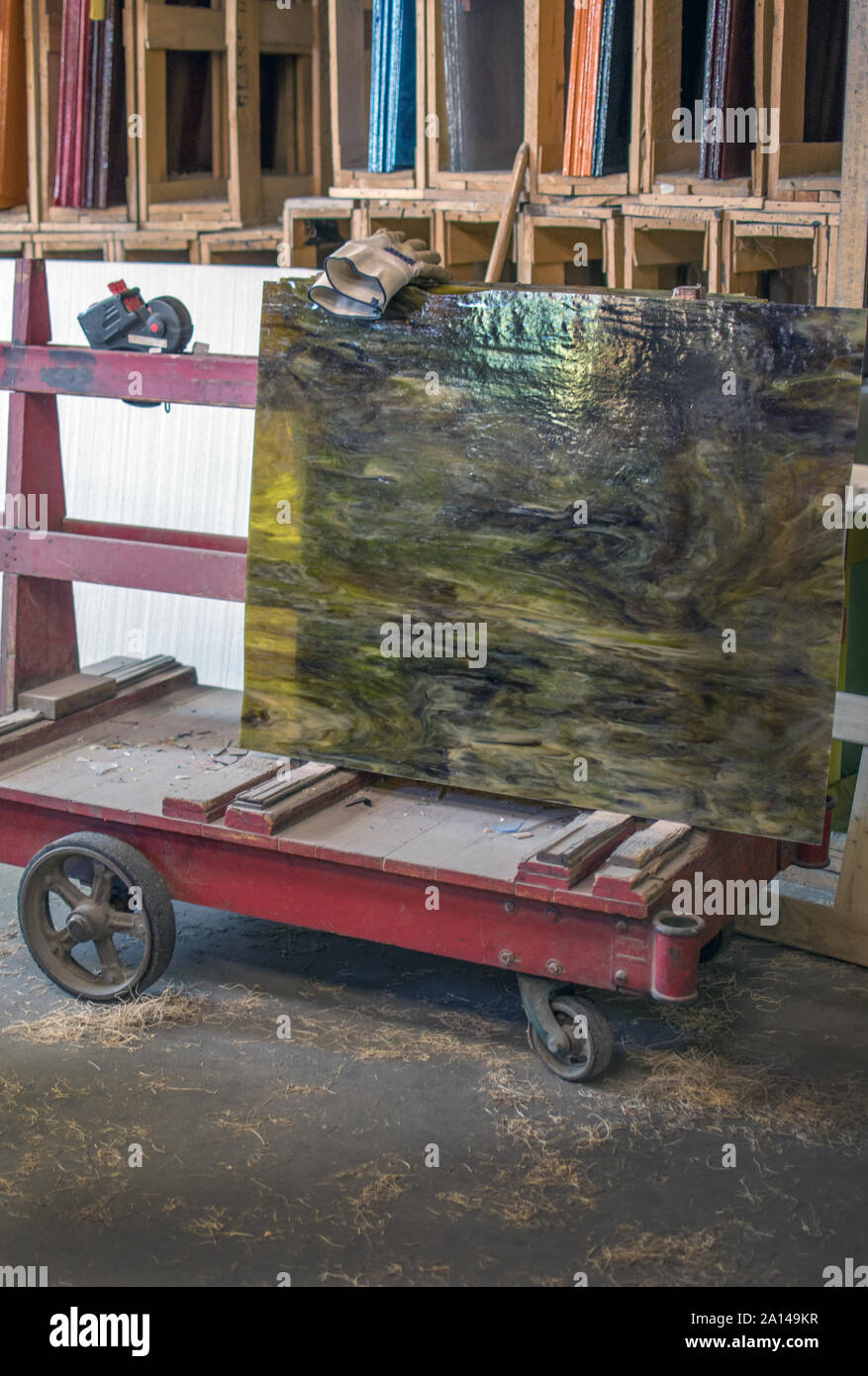 a metal cart with special sides and grooves help hold sheets of stained ...