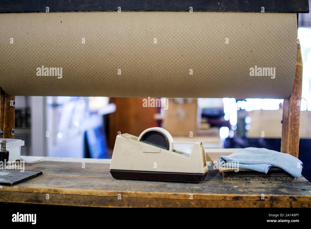 a roll of brown craft paper and a roll of tape is all set up to wrap ...