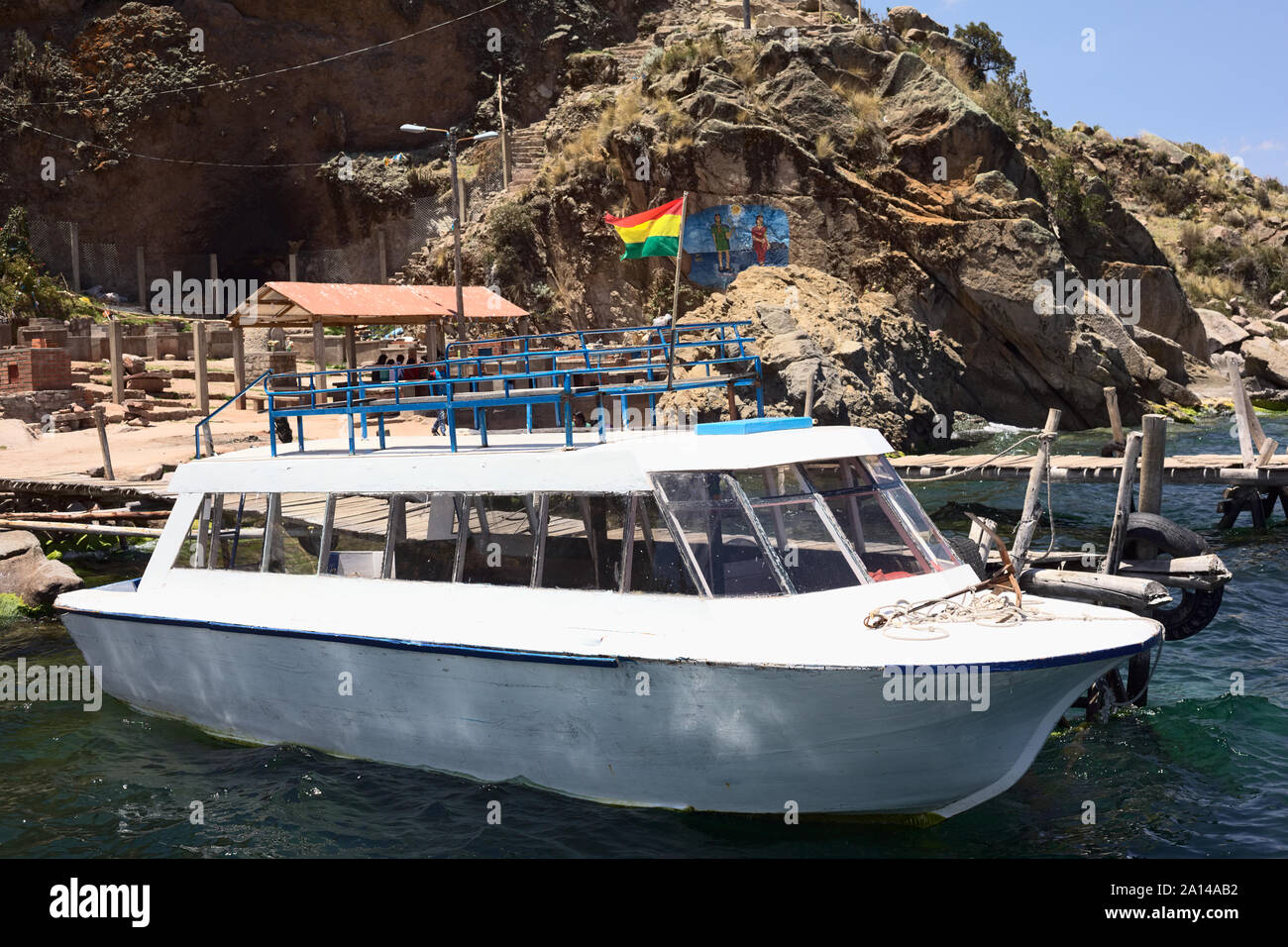 COPACABANA, BOLIVIA - OCTOBER 17, 2014: Tour boat anchoring at wooden ...