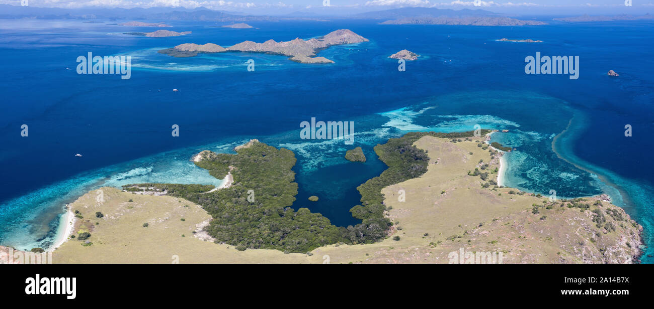 Bird's eye view shows scattered islands and fringing reefs in Komodo ...