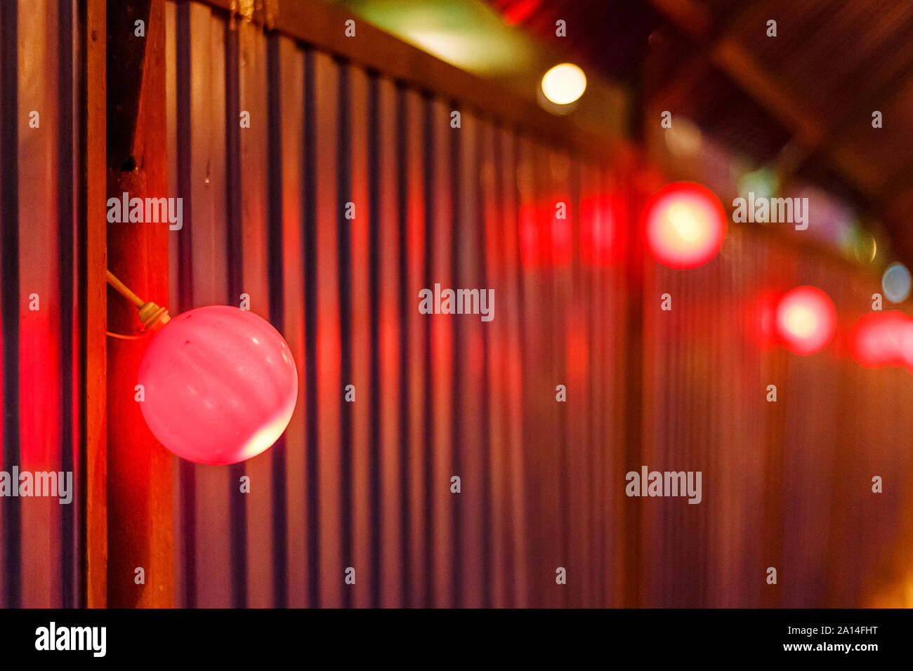 Bright red construction lamp in the mesh background. Warning of danger ...