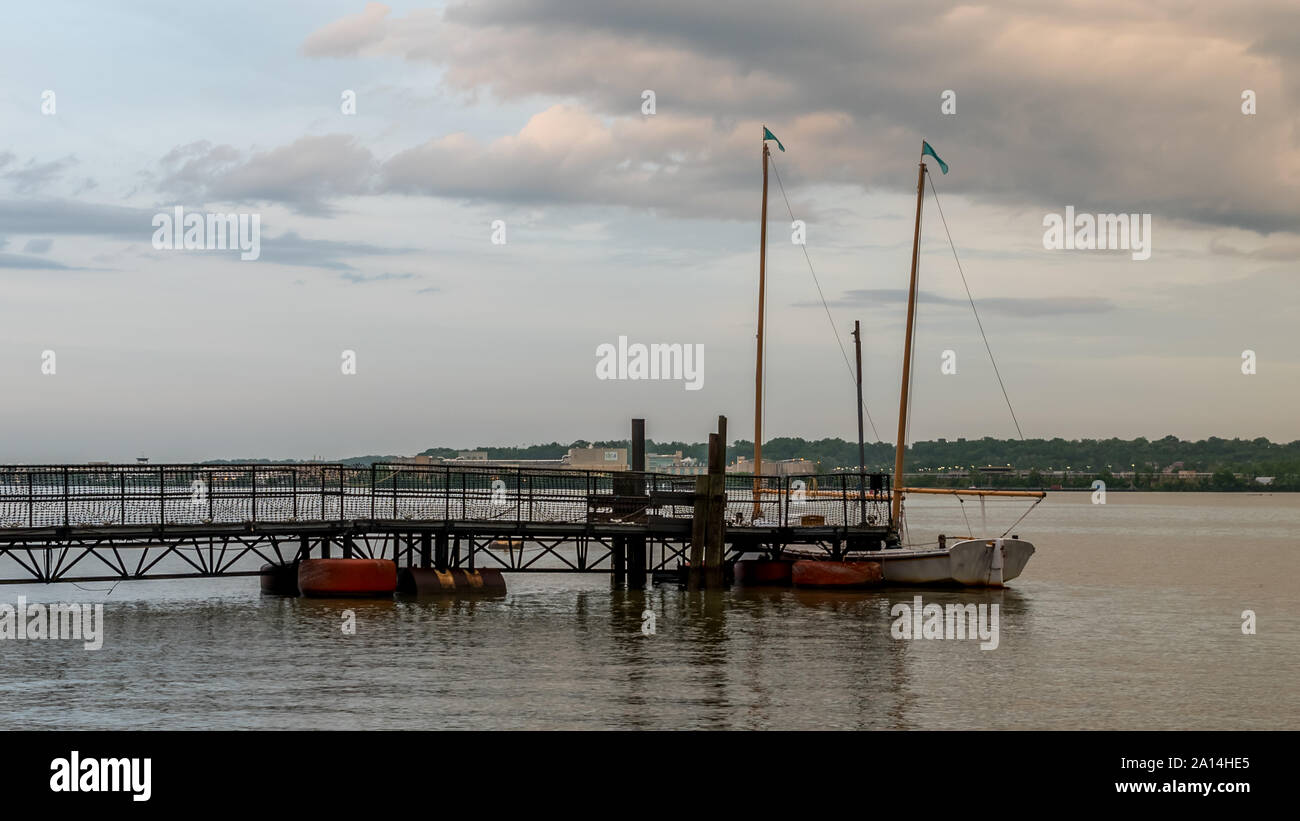White traditional ketch with wooden masts at dock on Potomac River ...