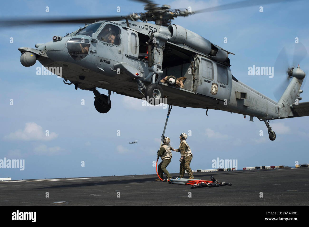 Marines secure a hoist sling to an MH-60S Seahawk helicopter Stock ...