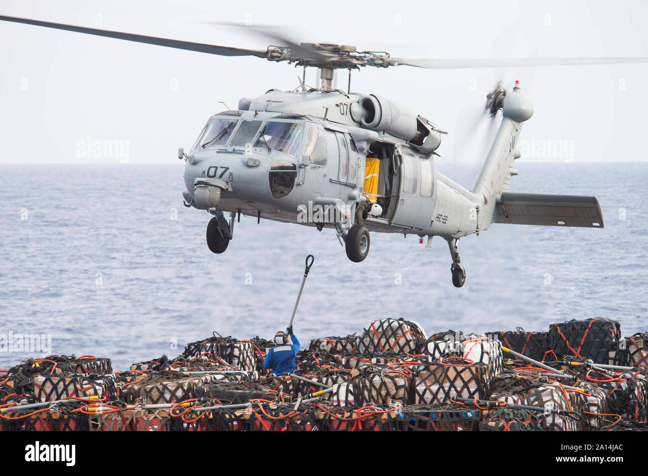 An MH-60S Seahawk helicopter picks up cargo from the flight deck of ...