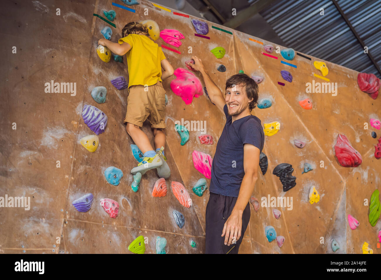 Dad and son at the climbing wall. Family sport, healthy lifestyle ...