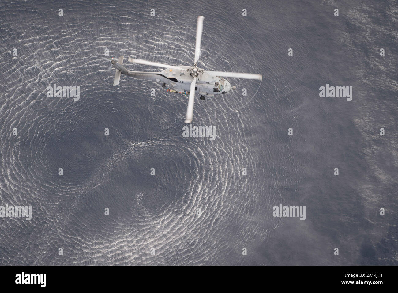 An MH-60R Seahawk helicopter hovers over the Pacific Ocean Stock Photo ...